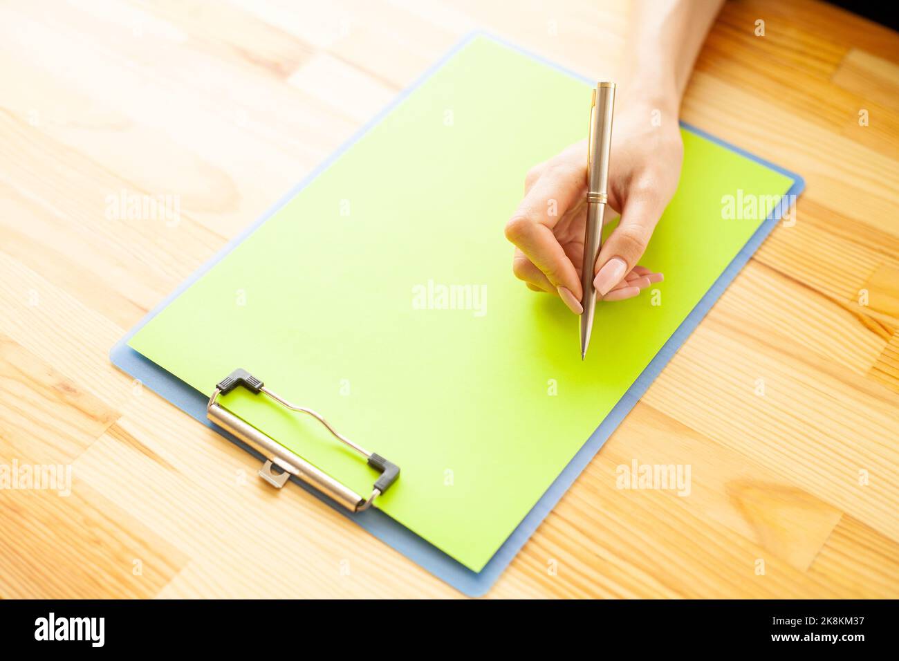 Office Hand Holding a Folder with a Green Color Paper and Pen on the ...