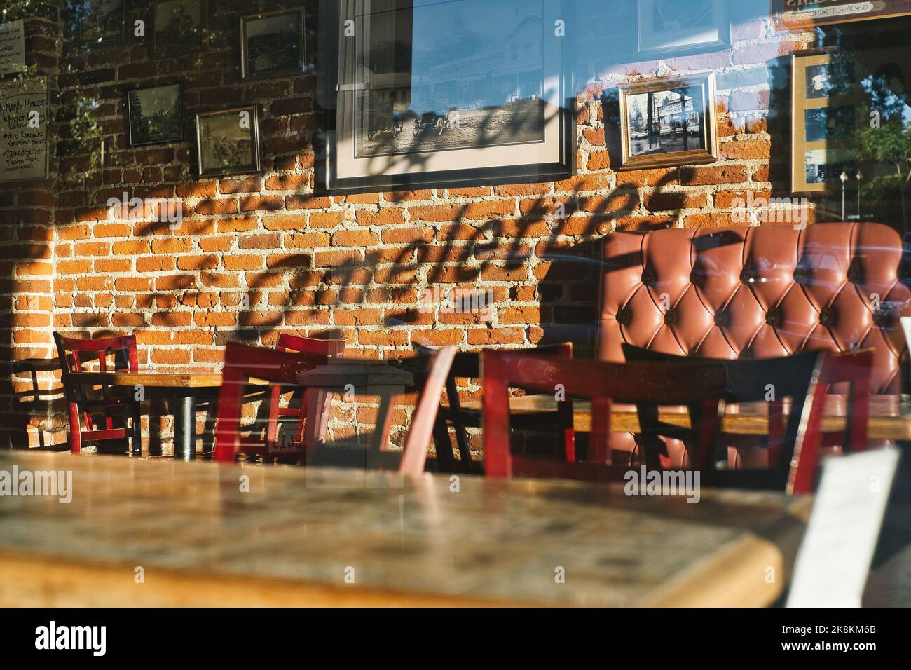 An "Omelettes" shadow reflected on brick wall of a restaurant seen ...