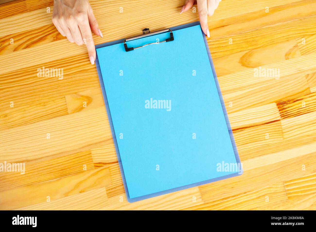 Office Hand Holding a Folder with a Blue Color Paper on the Background ...