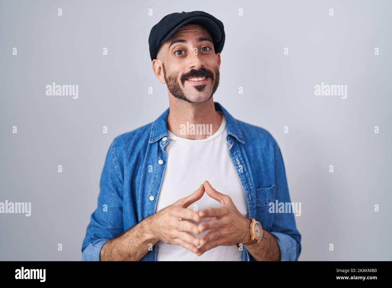 Hispanic man with beard standing over isolated background hands ...