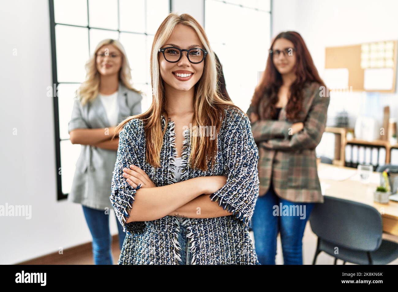 Group of young businesswoman smiling happy standing with arms crossed ...