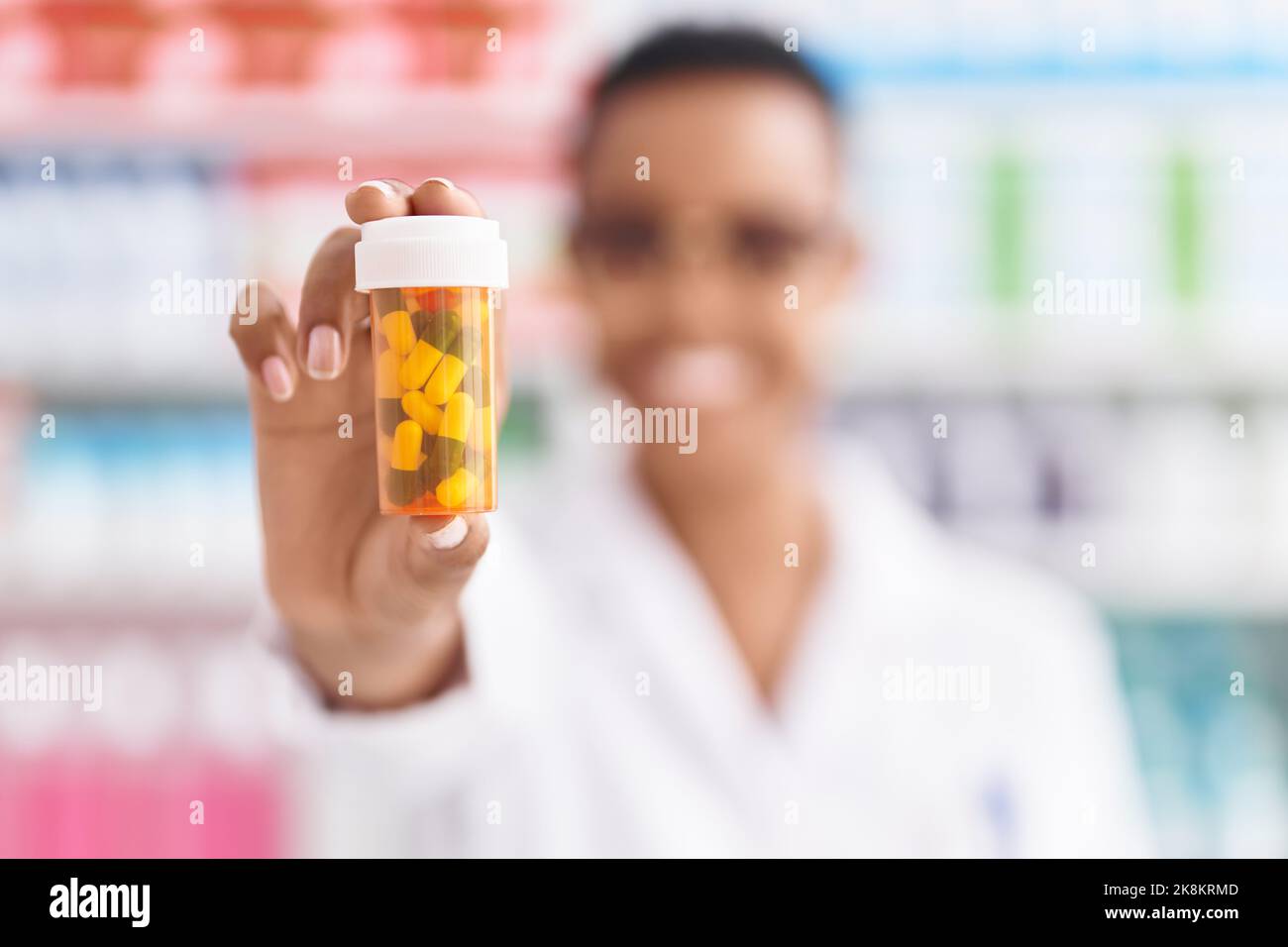 African american woman pharmacist smiling confident holding pills ...