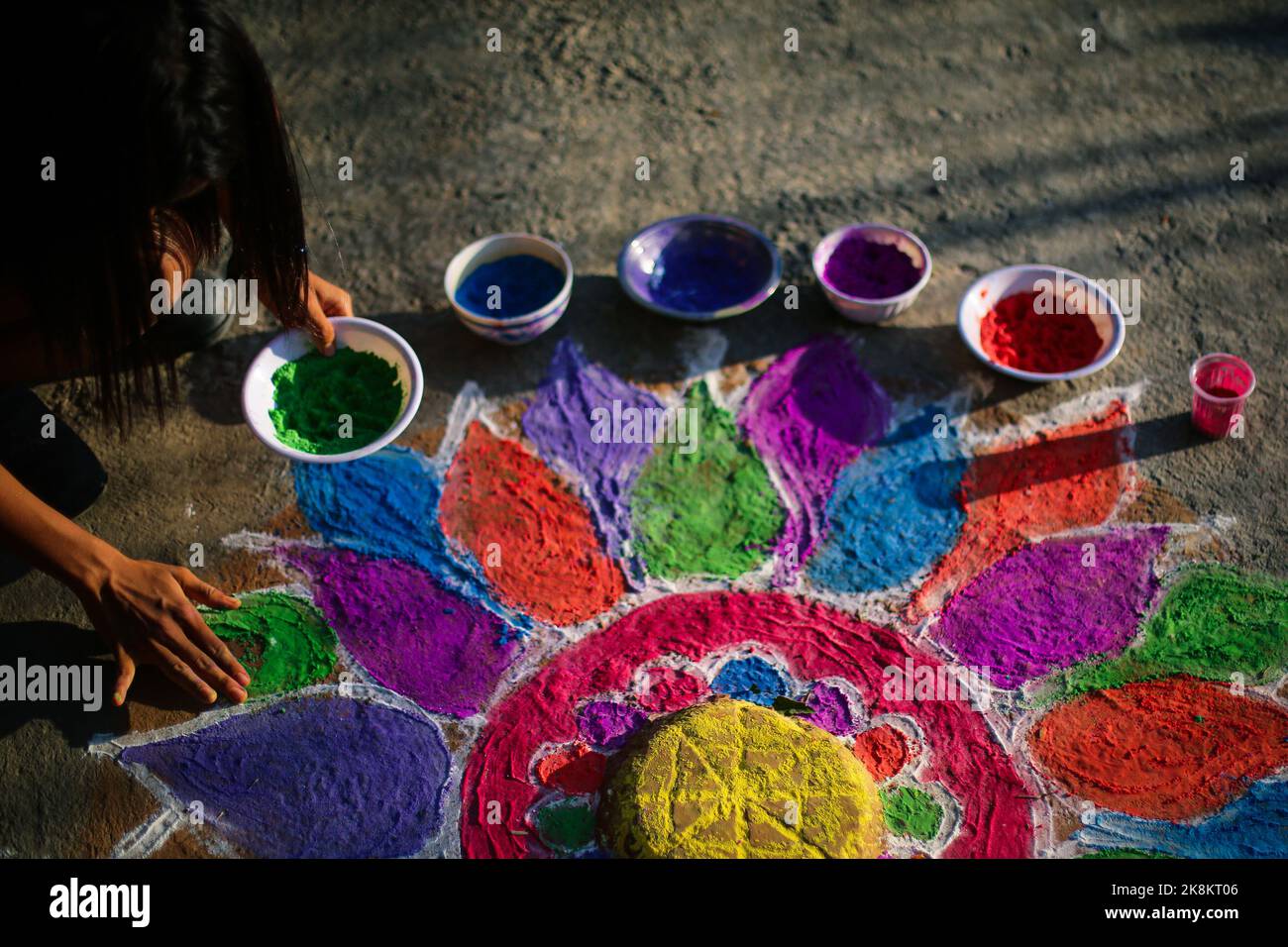 Nepal. 24th Oct, 2022. Girl making Rangoli li infornt of her house ...