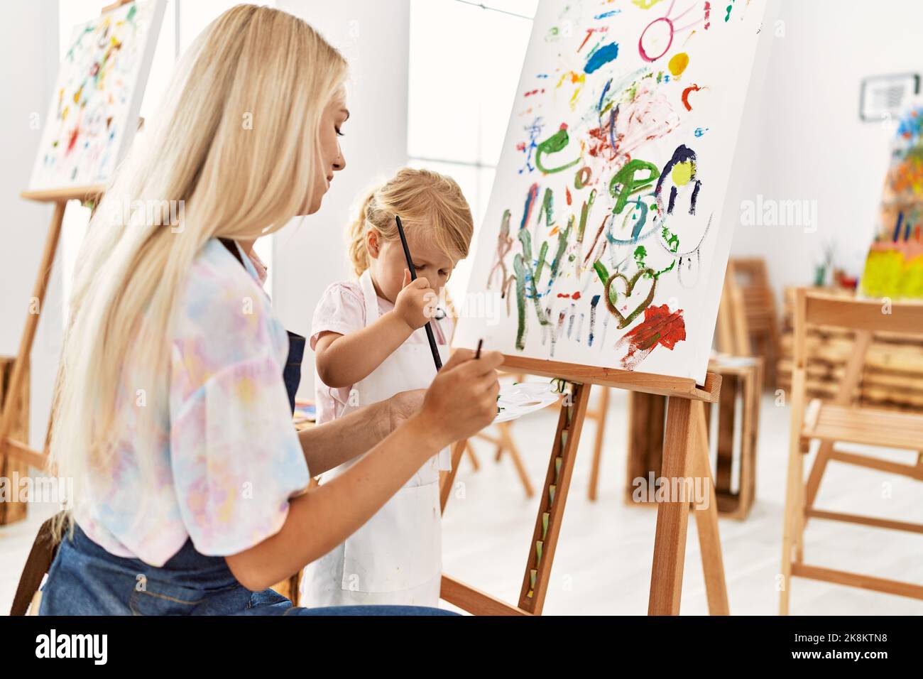 Mother and daughter concentrate drawing at art studio Stock Photo - Alamy