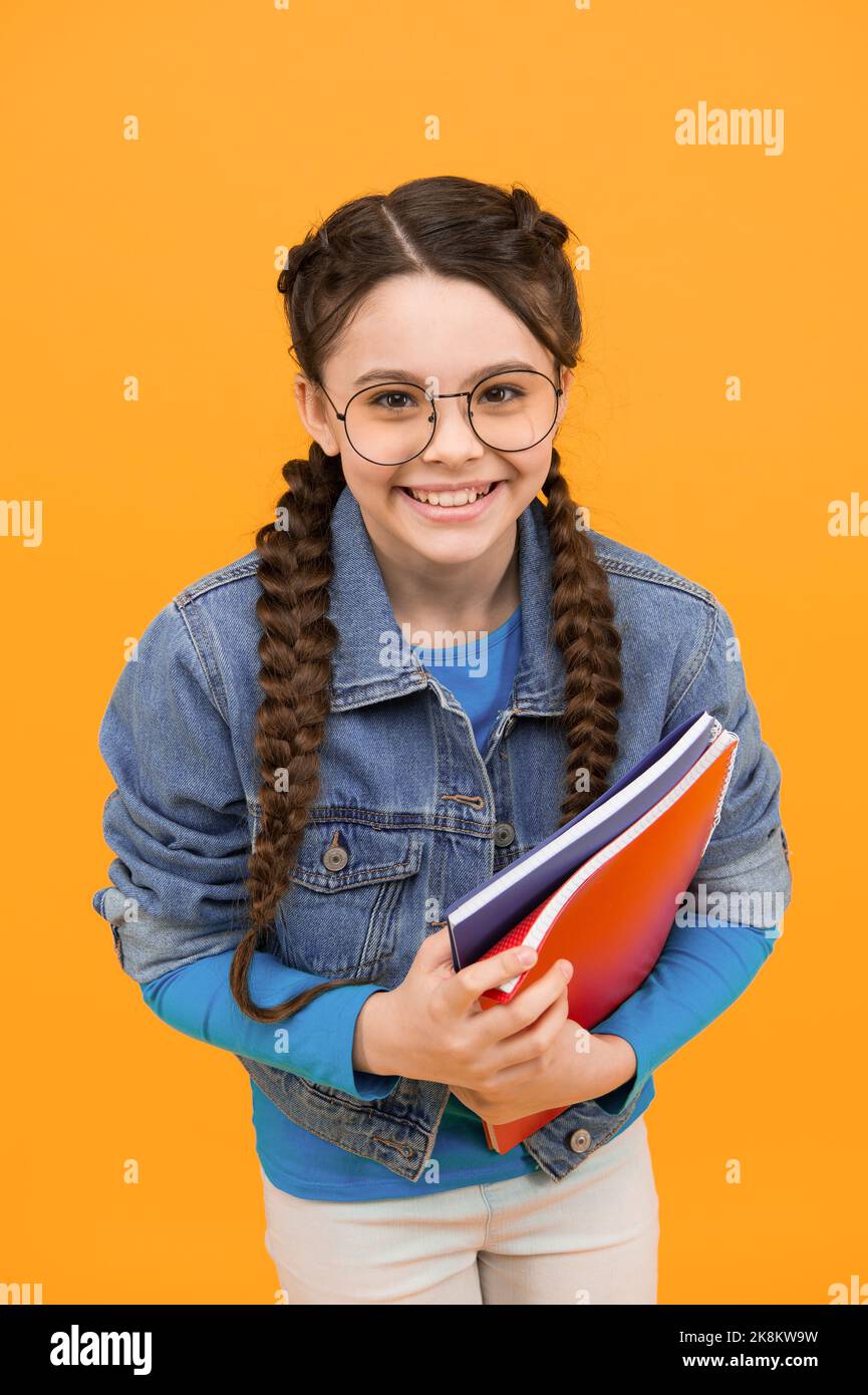 Happy kid with nerd look hold school books in casual fashion style ...