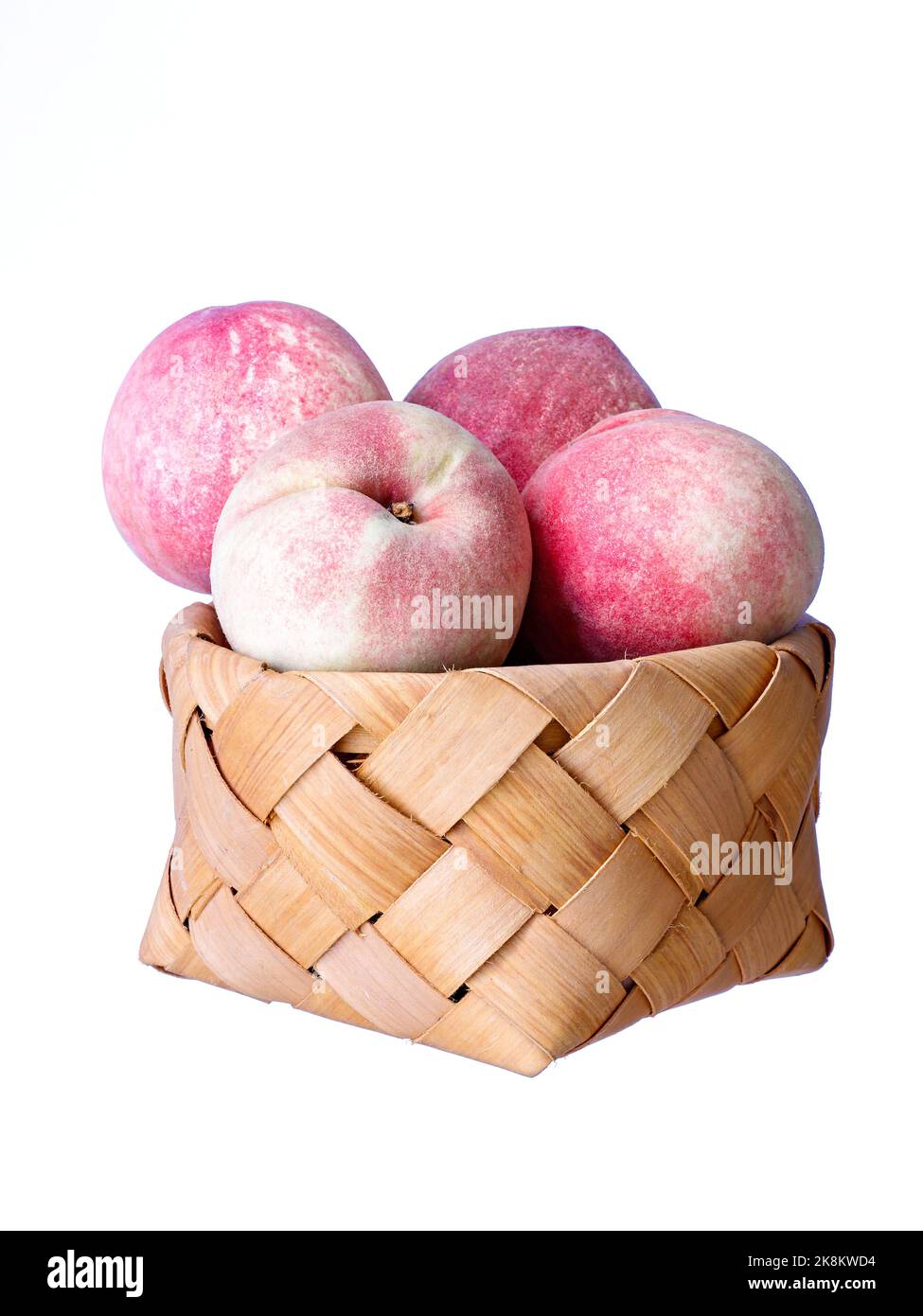 The fresh white peaches in a basket isolated on a white background ...