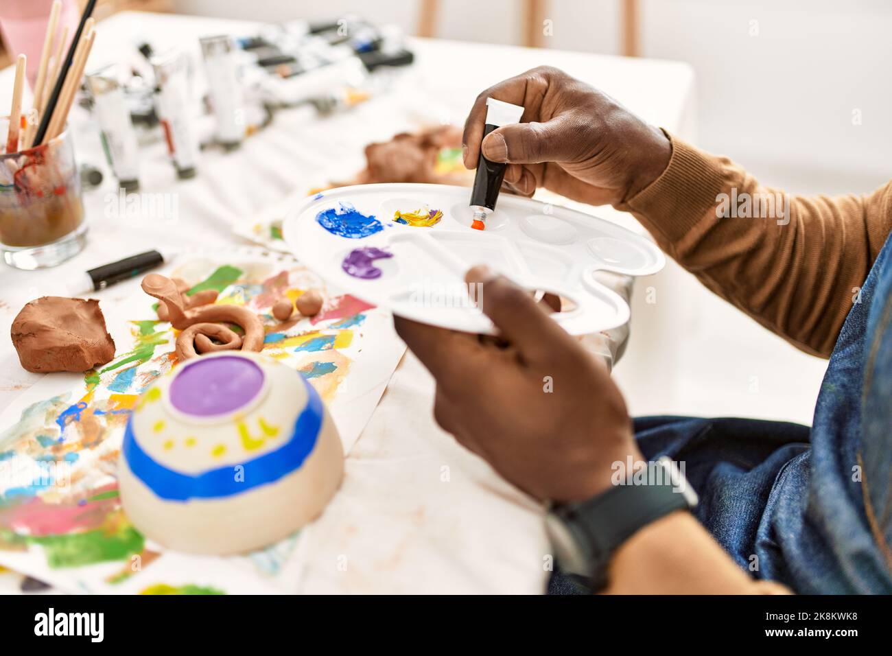 African american artist man mixing color on palette at art studio Stock ...