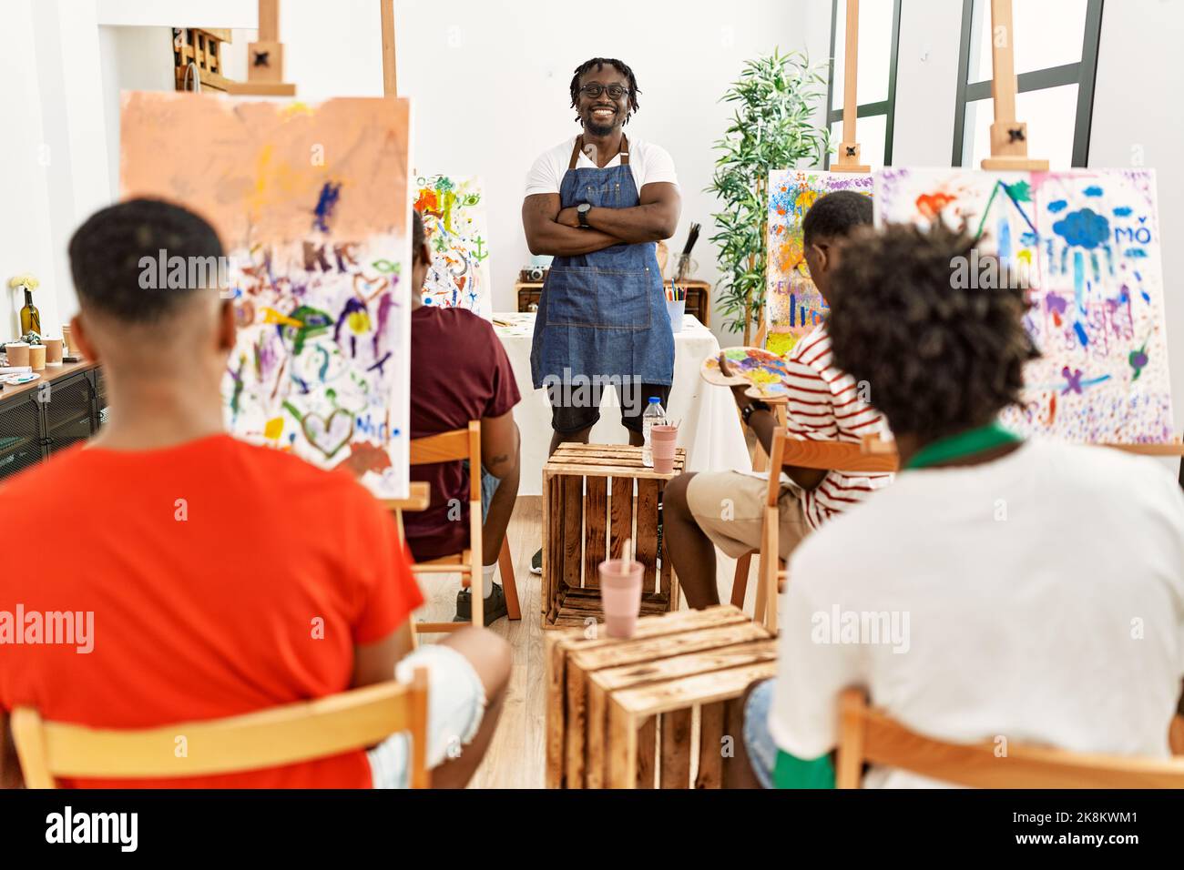 Group of young african american artist students drawing in paint class ...