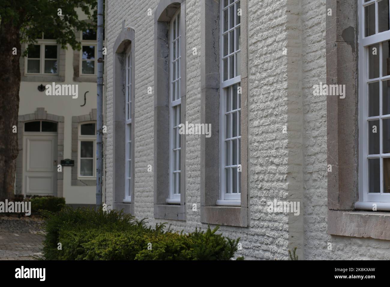 The exterior of a beautiful white brick building Stock Photo - Alamy