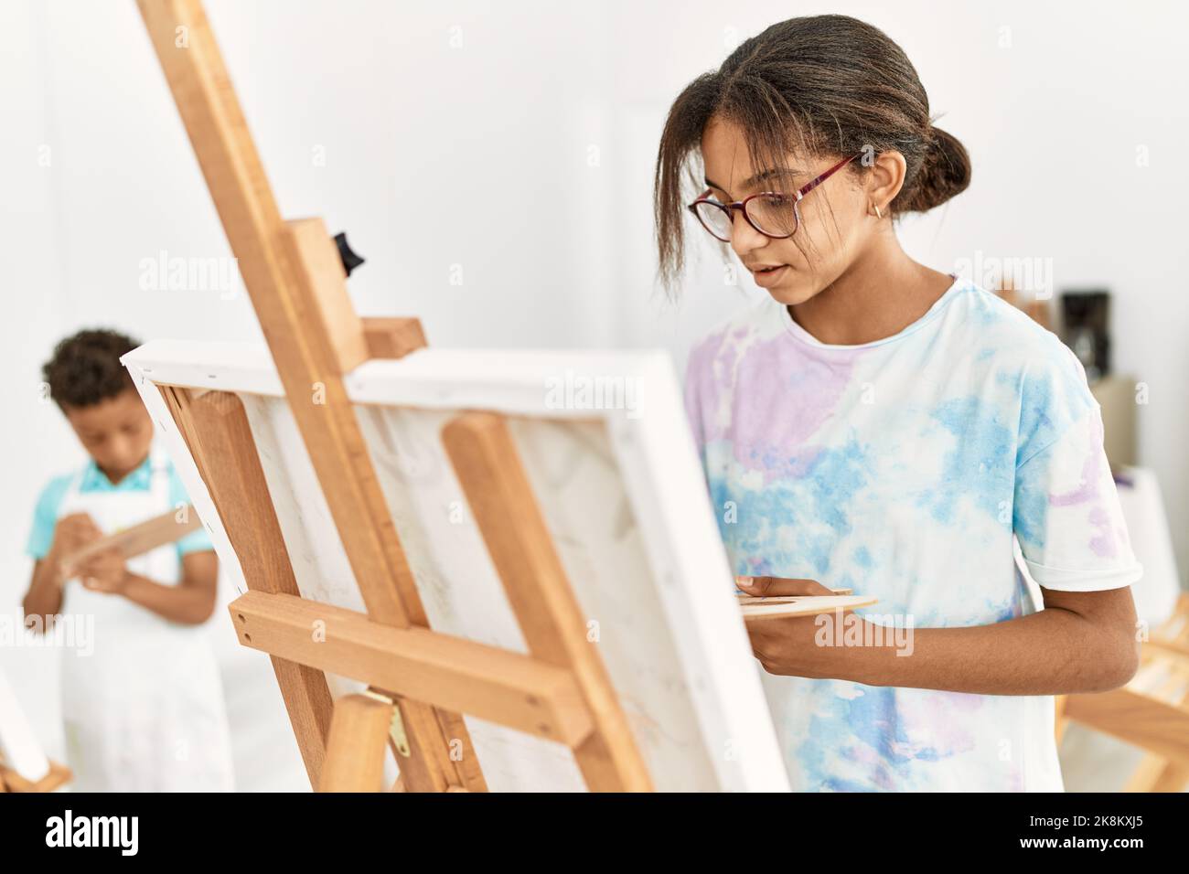 Brother and sister concentrate drawing at art studio Stock Photo - Alamy
