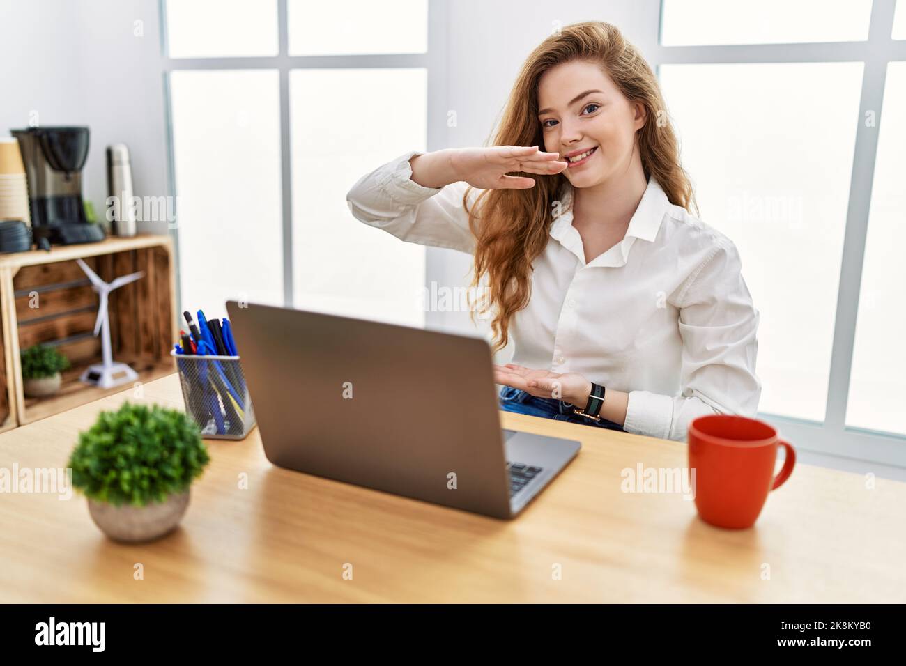Young caucasian woman working at the office using computer laptop ...