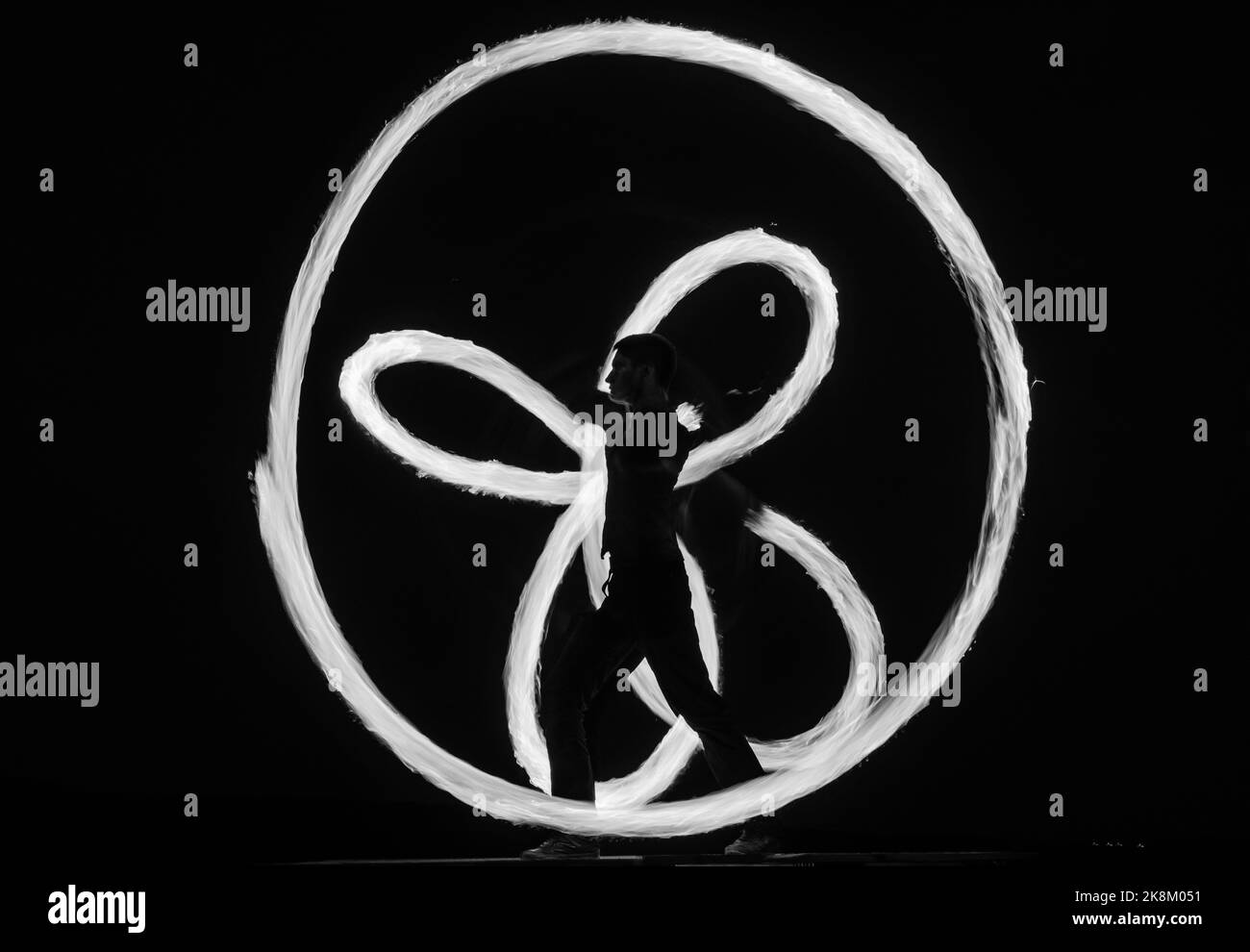 Having tricks for celebration. Man perform fire tricks in darkness ...