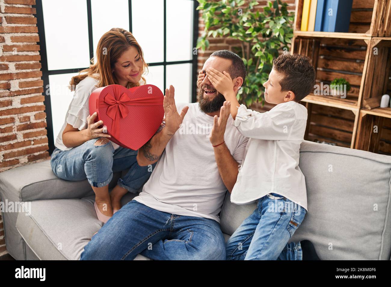 Family surprise father with heart box gift at home Stock Photo - Alamy