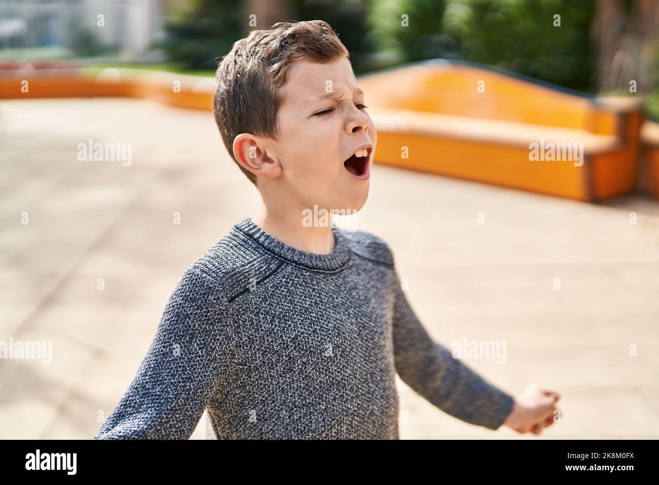 Blond child screaming at park Stock Photo - Alamy