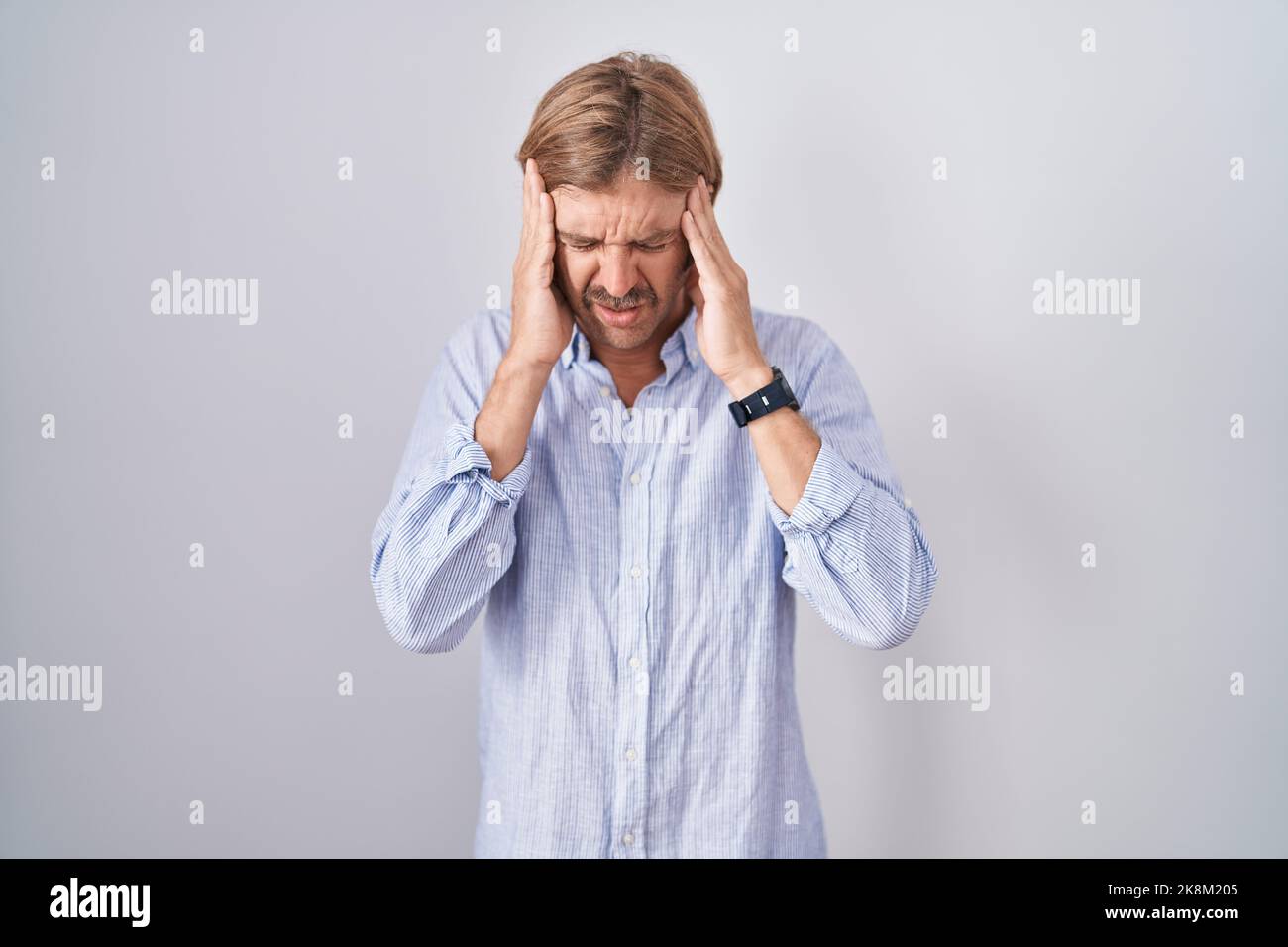 Caucasian man with mustache standing over white background with hand on ...