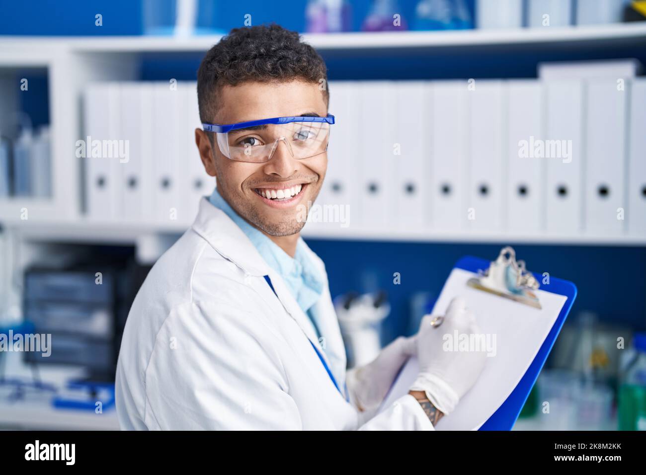 African american man scientist writing on document at laboratory Stock ...