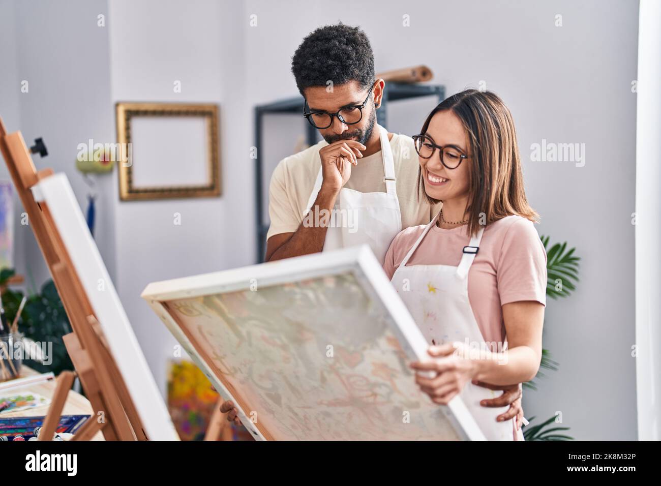 Man and woman artists smiling confident looking draw at art studio ...