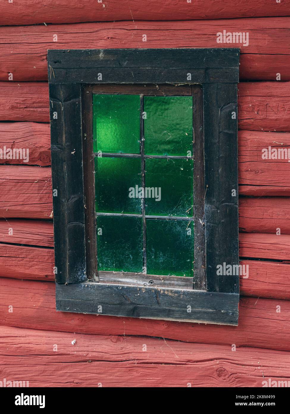 Window with green glass of an old log house at Valdresmusea Folk Museum ...