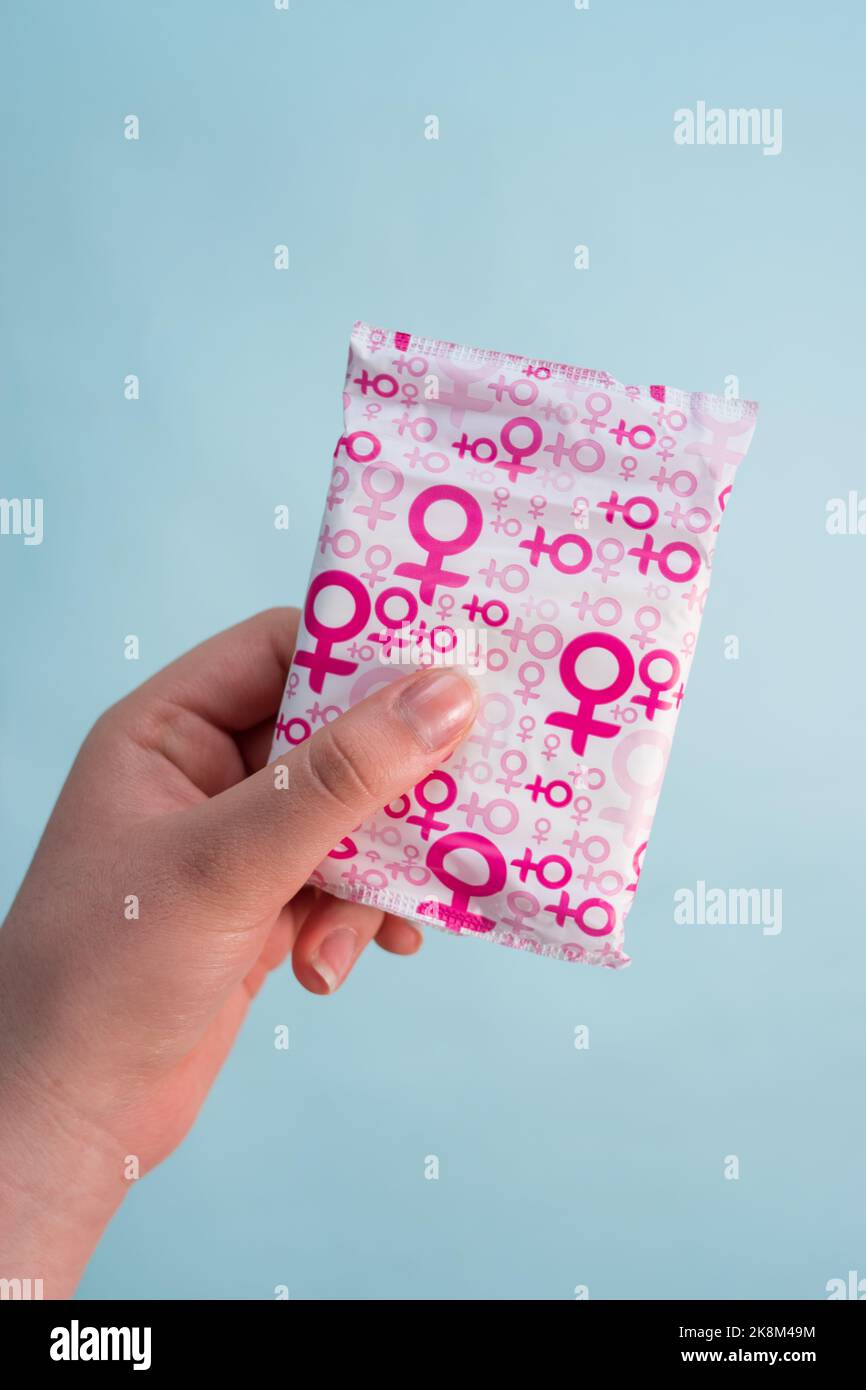A women's hygiene pad and pink women's symbol on the package Stock ...