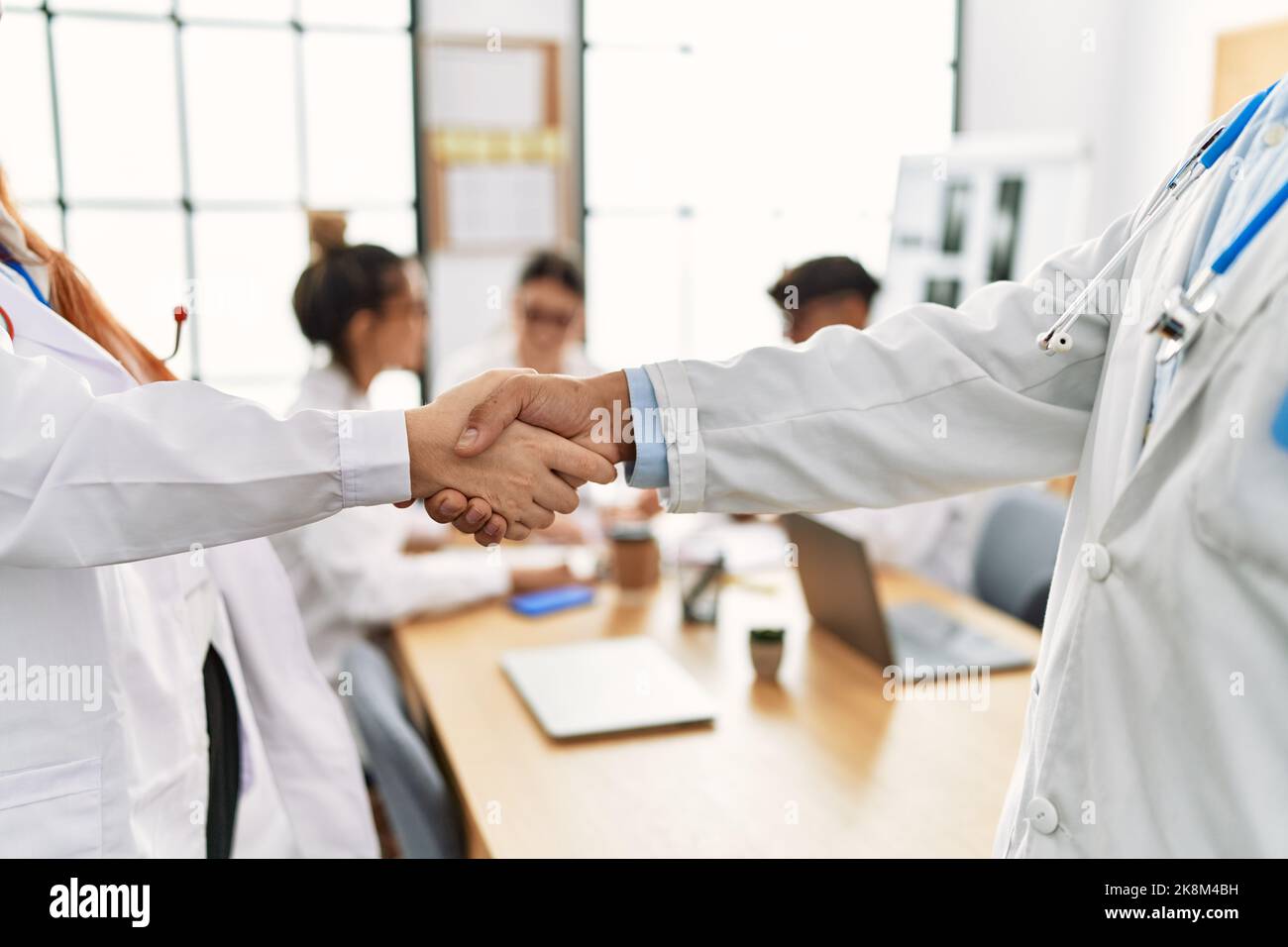 Group of doctor clapping to partners handshake in a medical meeting at ...