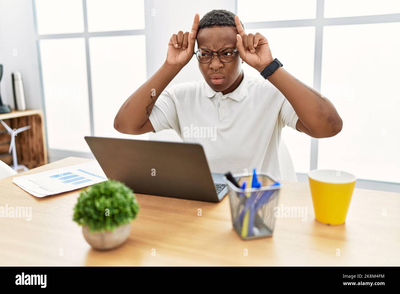 Young african man working at the office using computer laptop doing ...