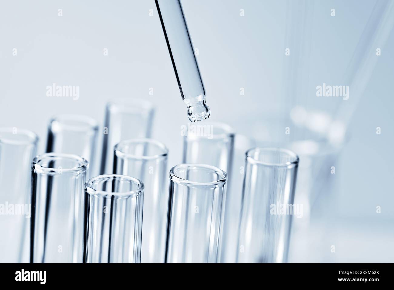 Laboratory glassware with dropper into test tube close up macro ...