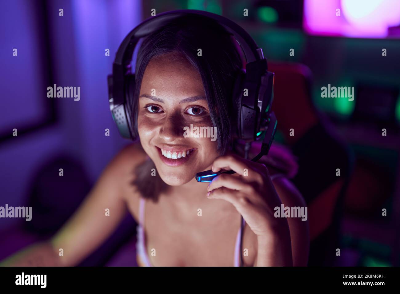 Young hispanic woman streamer smiling confident playing video game at ...