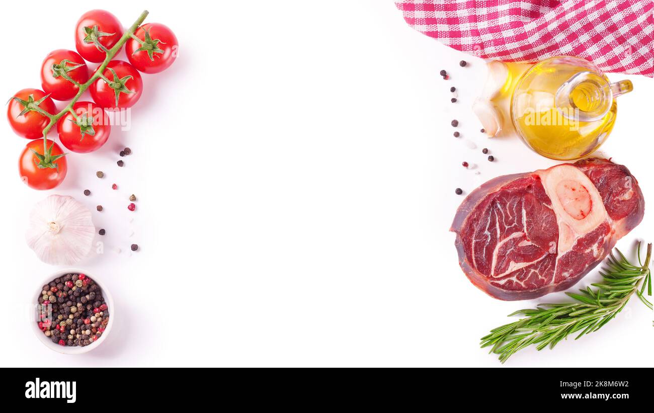 ingredients for cooking. raw beef steak with bone and spices, tomatoes ...