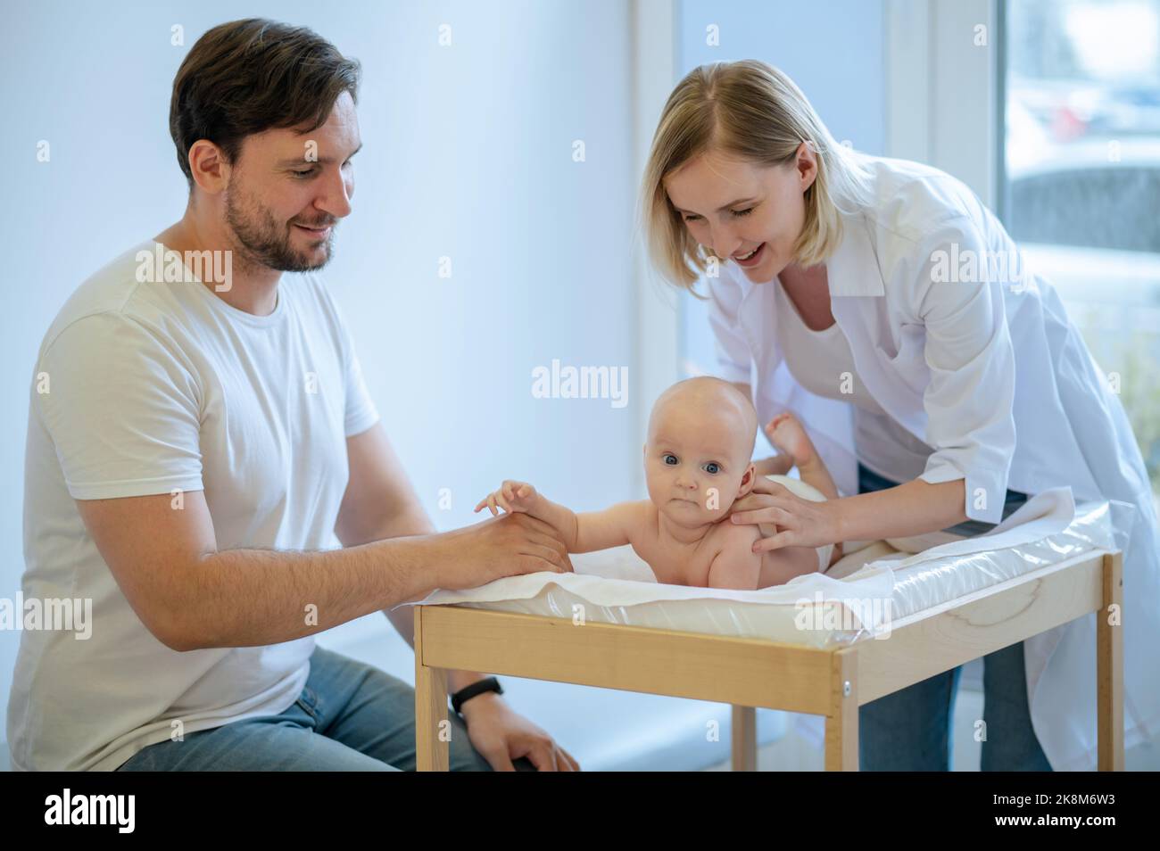 Pediatrician checking the reflexes of a newborn child Stock Photo - Alamy