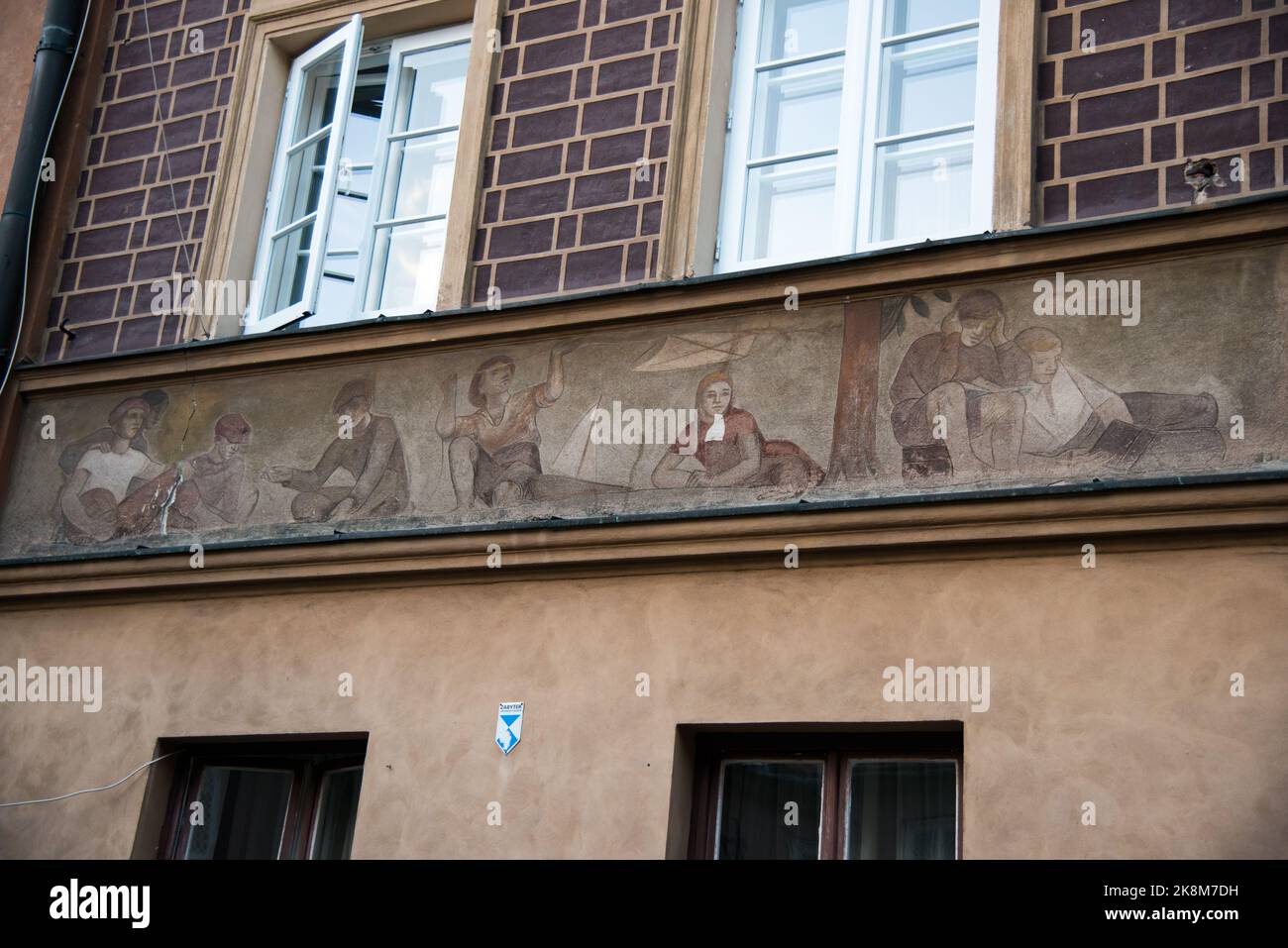 The exterior of stone and brick building with fantastic drawings in ...