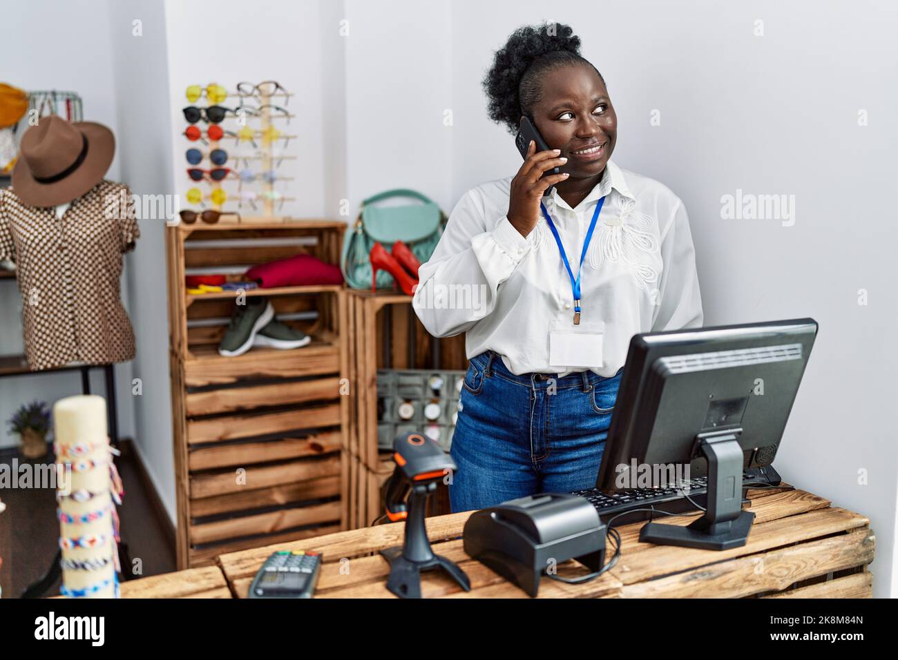 Young african american woman shopkeeper talking on the smartphone ...