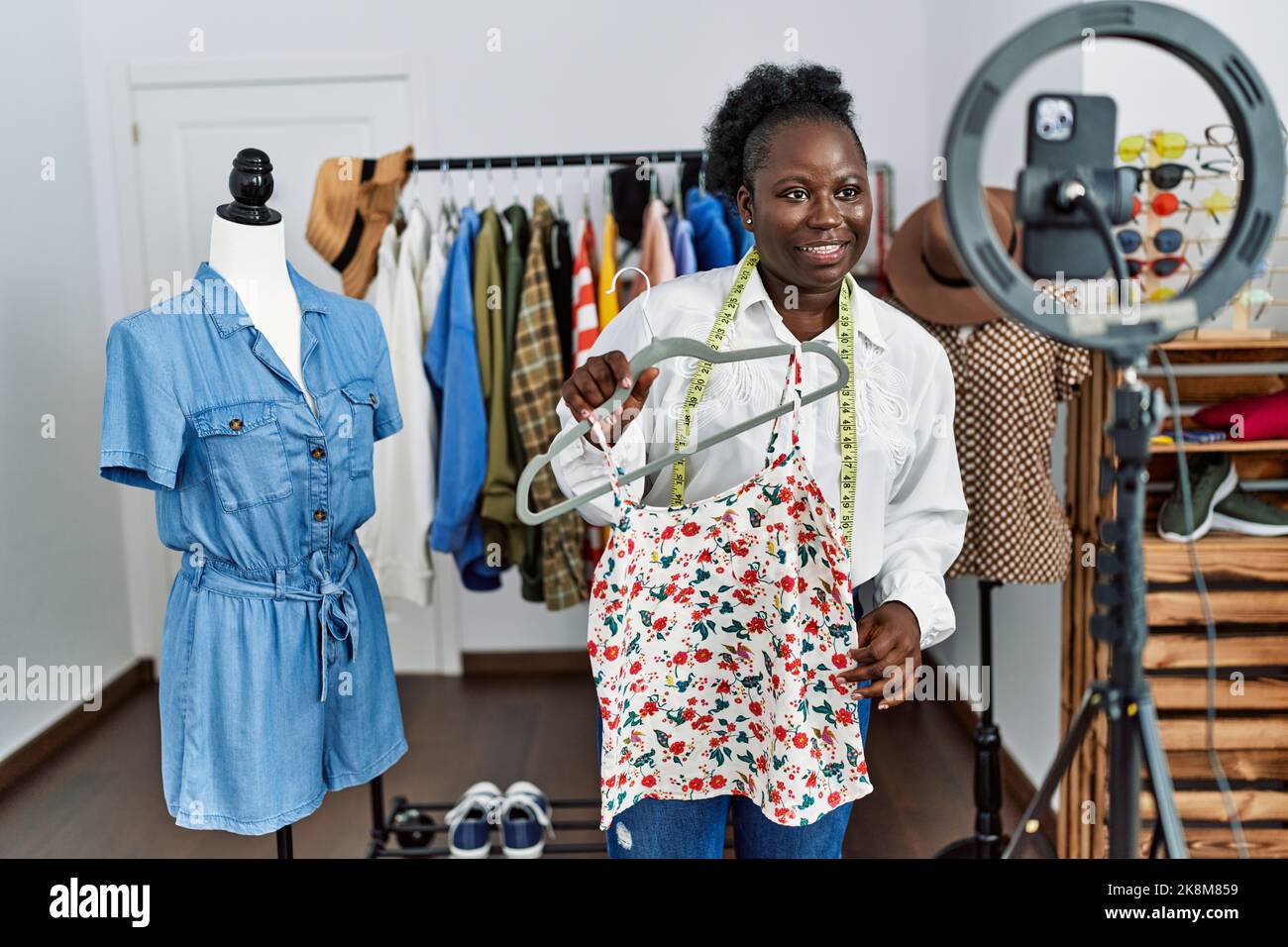 Young african american woman shopkeeper selling clothes online at ...