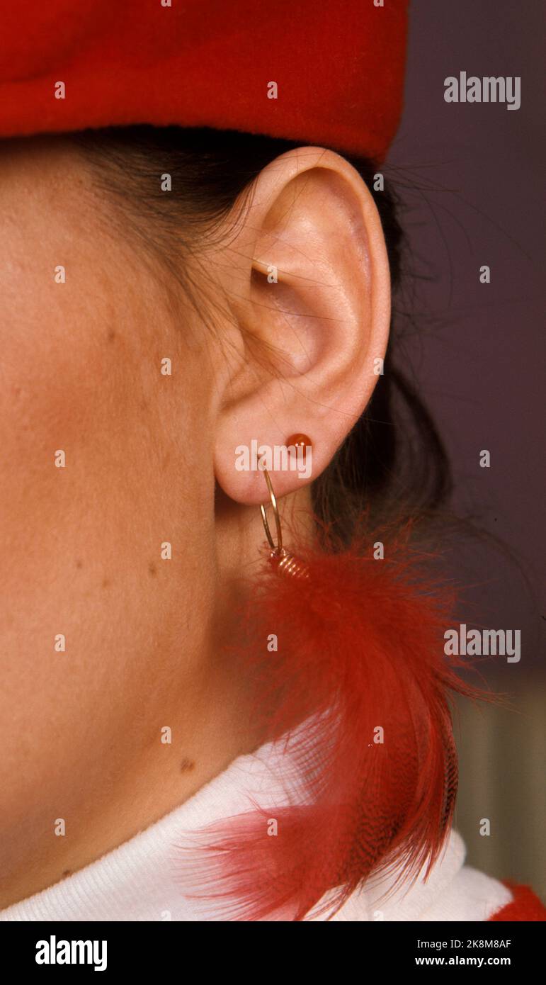 Two holes in her ear with earrings hi-res stock photography and images ...