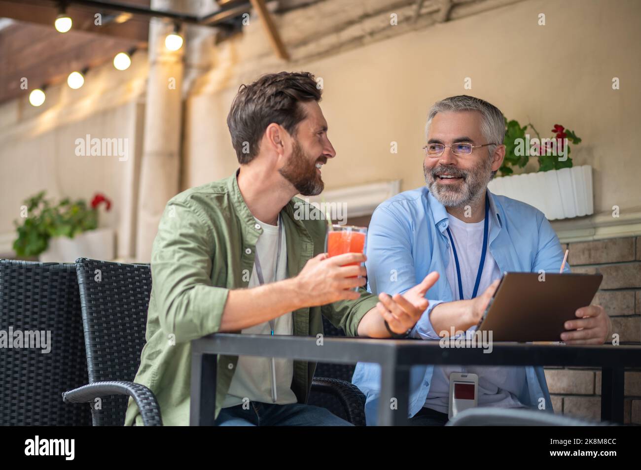 Two colleagues having dinner and looking contented Stock Photo - Alamy