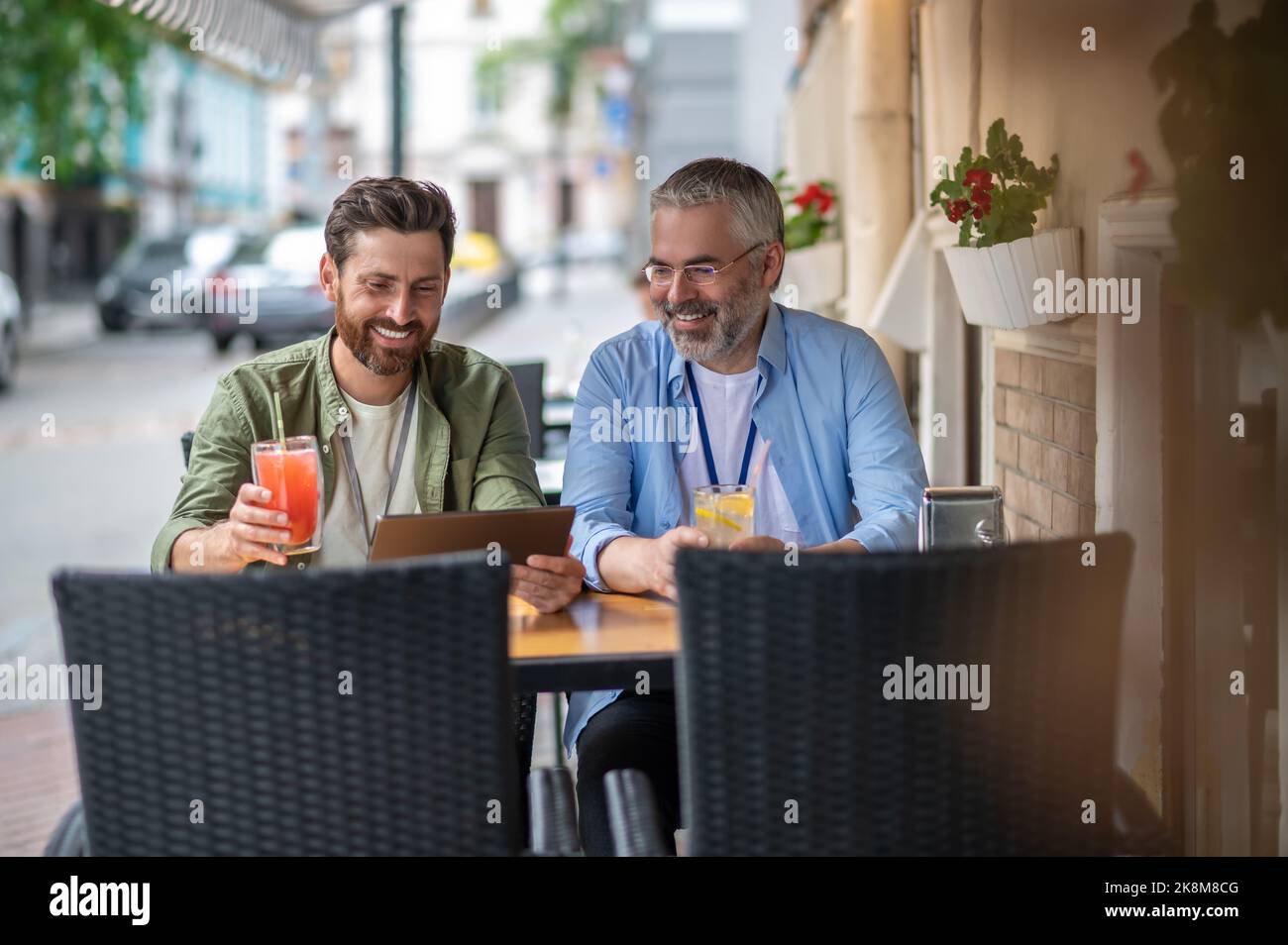 Two colleagues having dinner and looking contented Stock Photo - Alamy