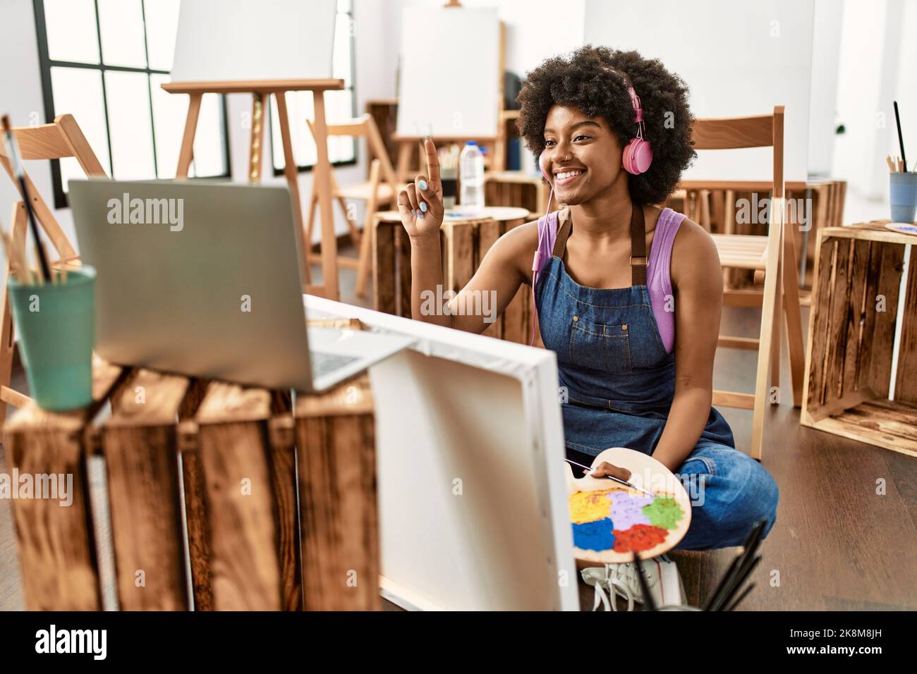 Young african american woman having online drawing class at art studio ...