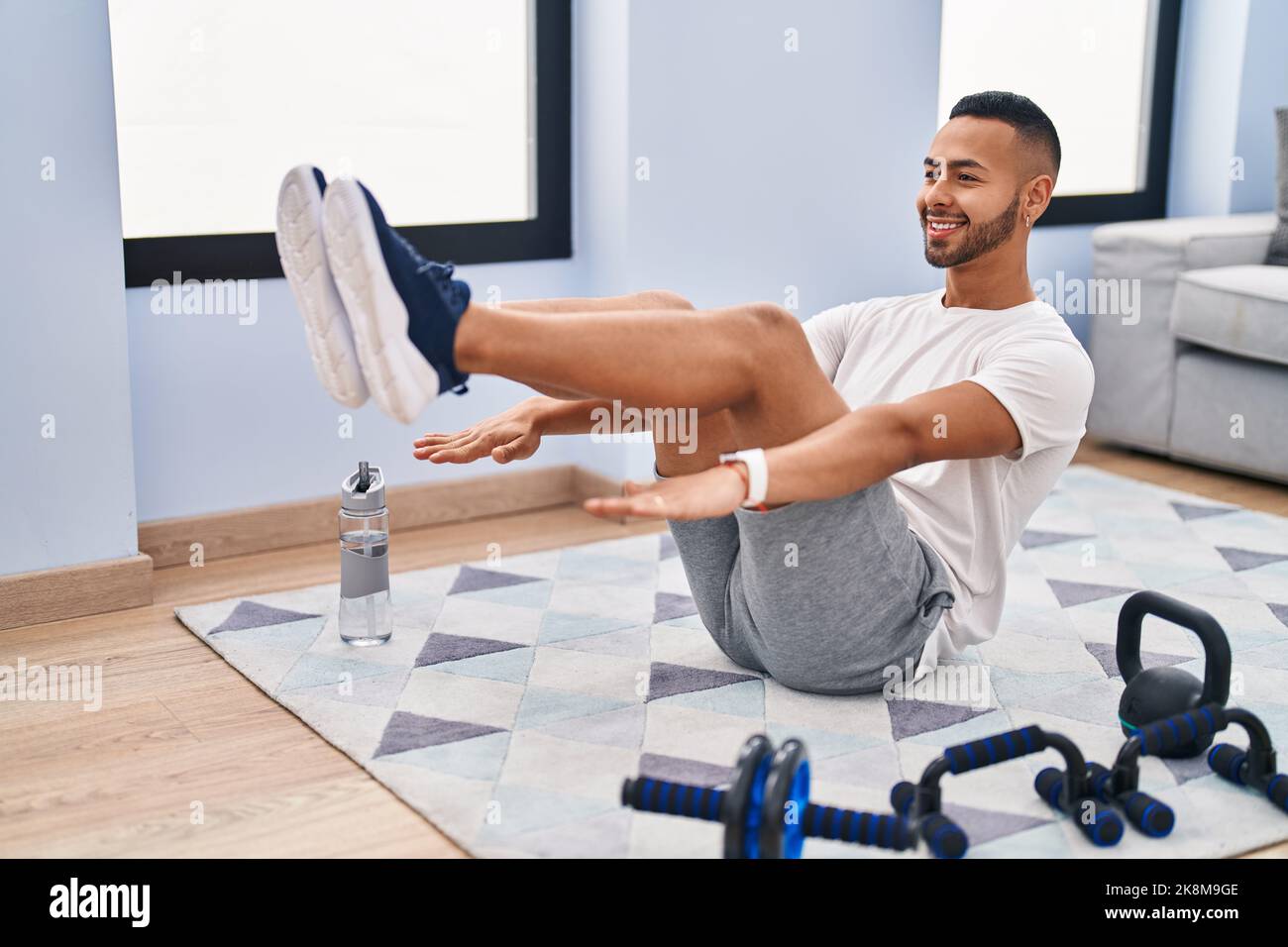 African american man smiling confident training abs exercise at home ...