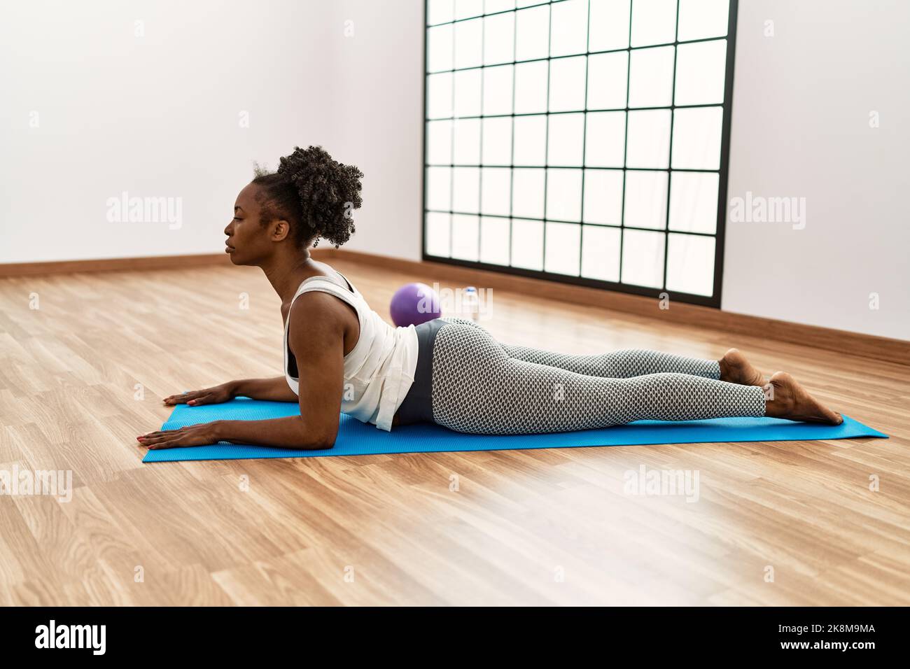 African american woman stretching back at sport center Stock Photo - Alamy