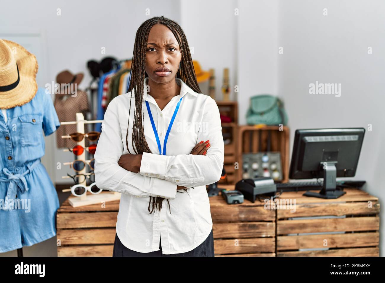 Black woman with braids working as manager at retail boutique skeptic ...