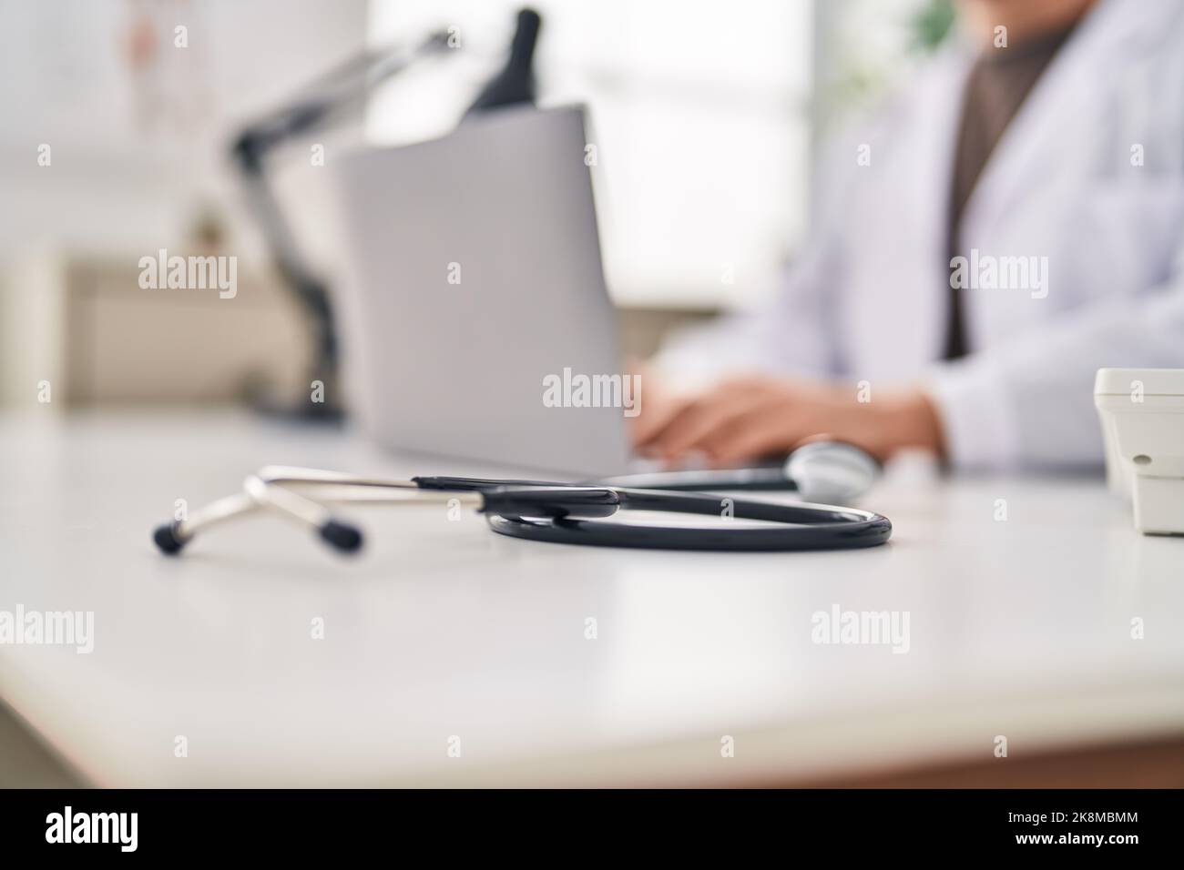Young caucasian man doctor using laptop working at clinic Stock Photo ...