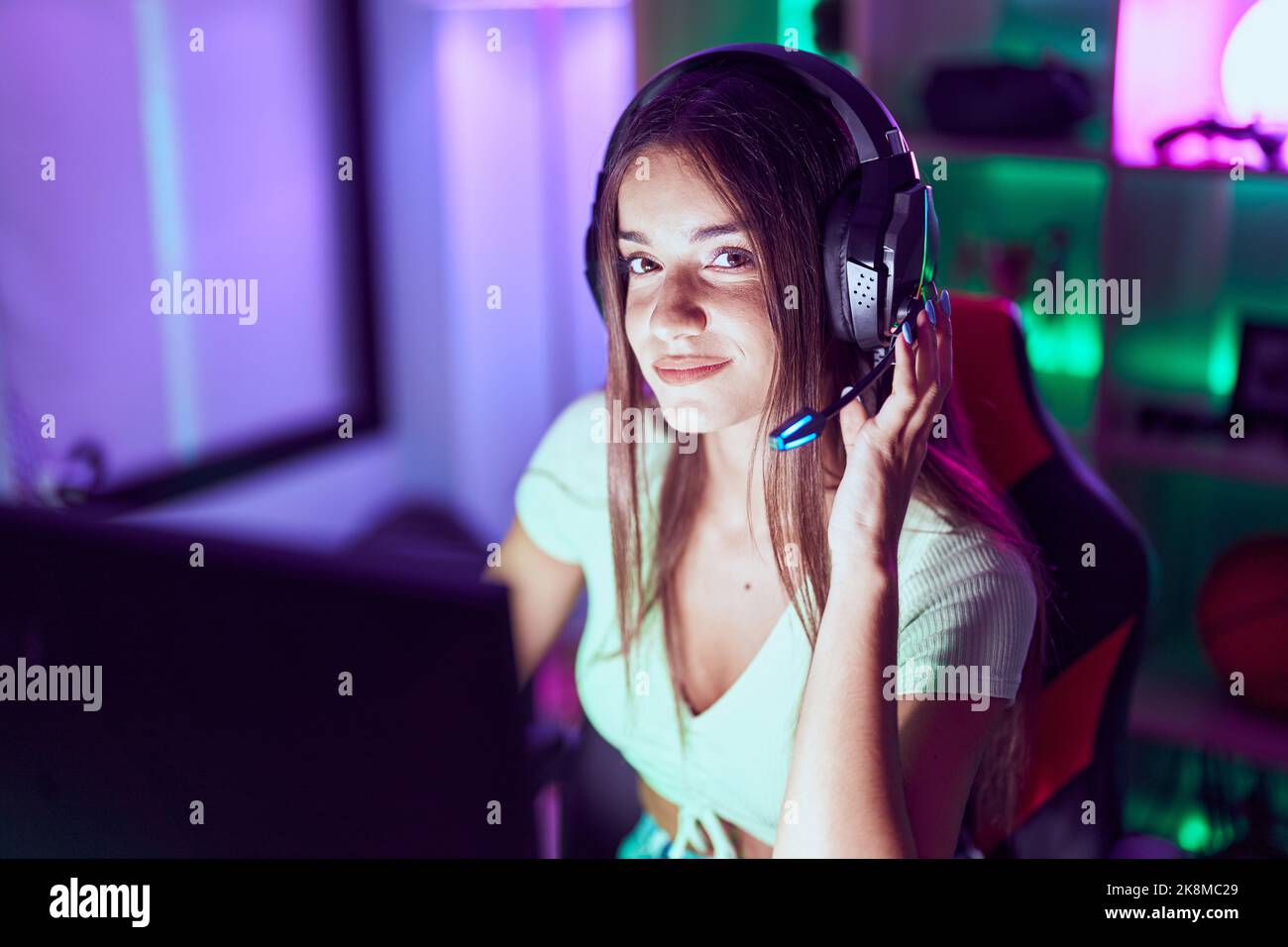 Young beautiful hispanic woman streamer playing video game using ...