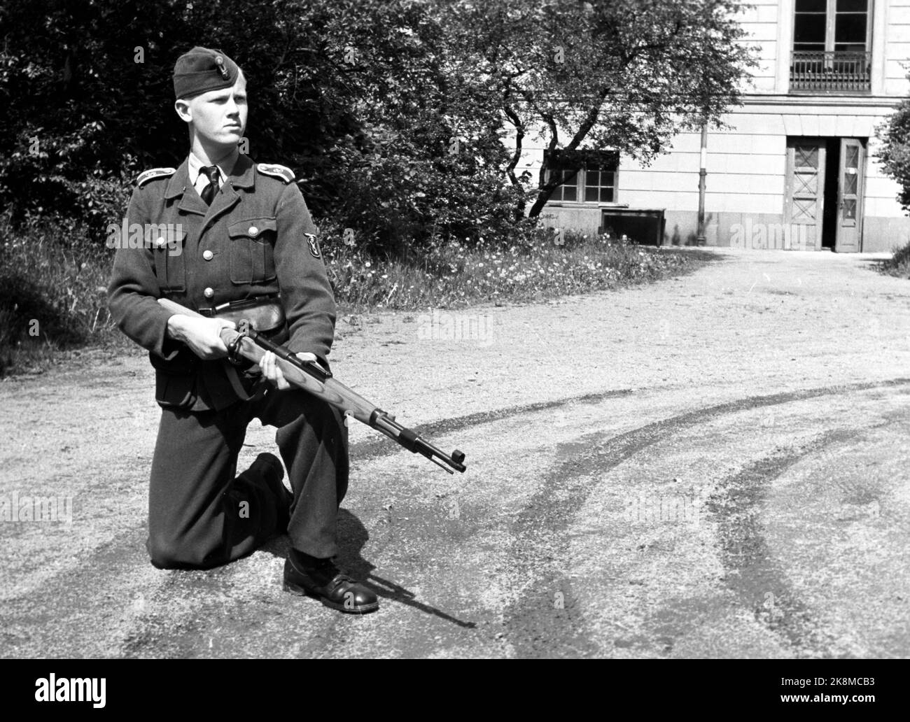 WW2 Oslo 19440616 Driver's yard with rifle. Photo: NTB *** Photo not ...