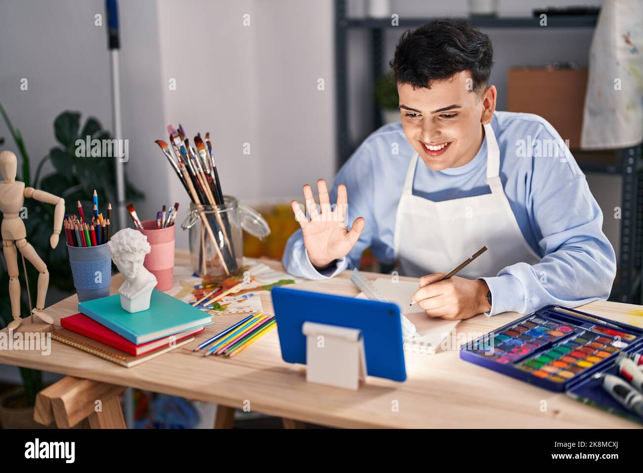 Young non binary man artist having online drawing class at art studio ...