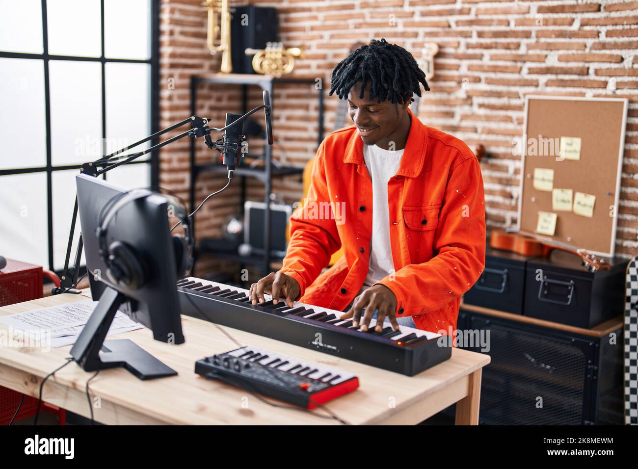 African american man musician playing piano keyboard at music studio ...