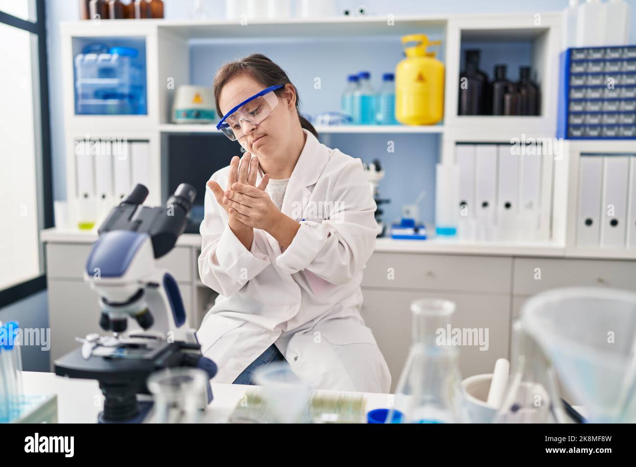 Hispanic girl with down syndrome working at scientist laboratory ...