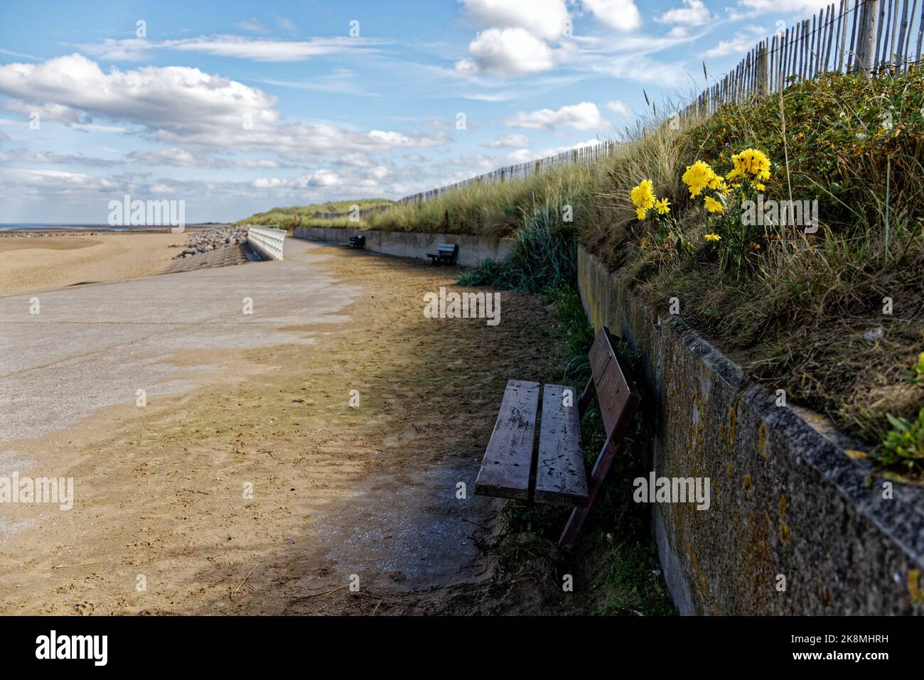 A public bench on a concrete sea defence structure at Barkby Beach ...