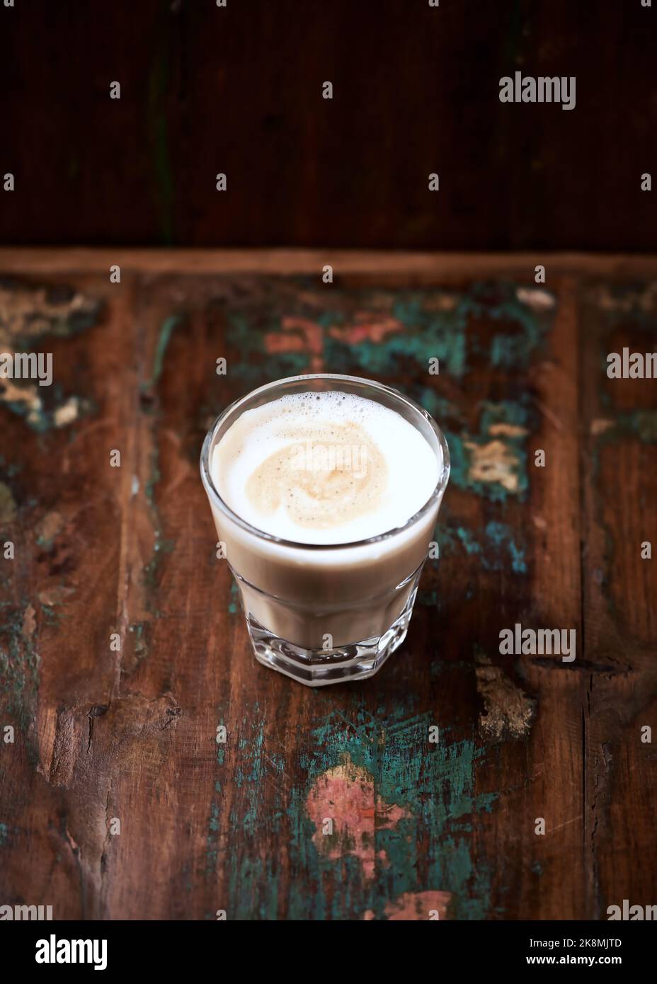 Coffee with milk on rustic wooden background. Soft focus. Close up ...