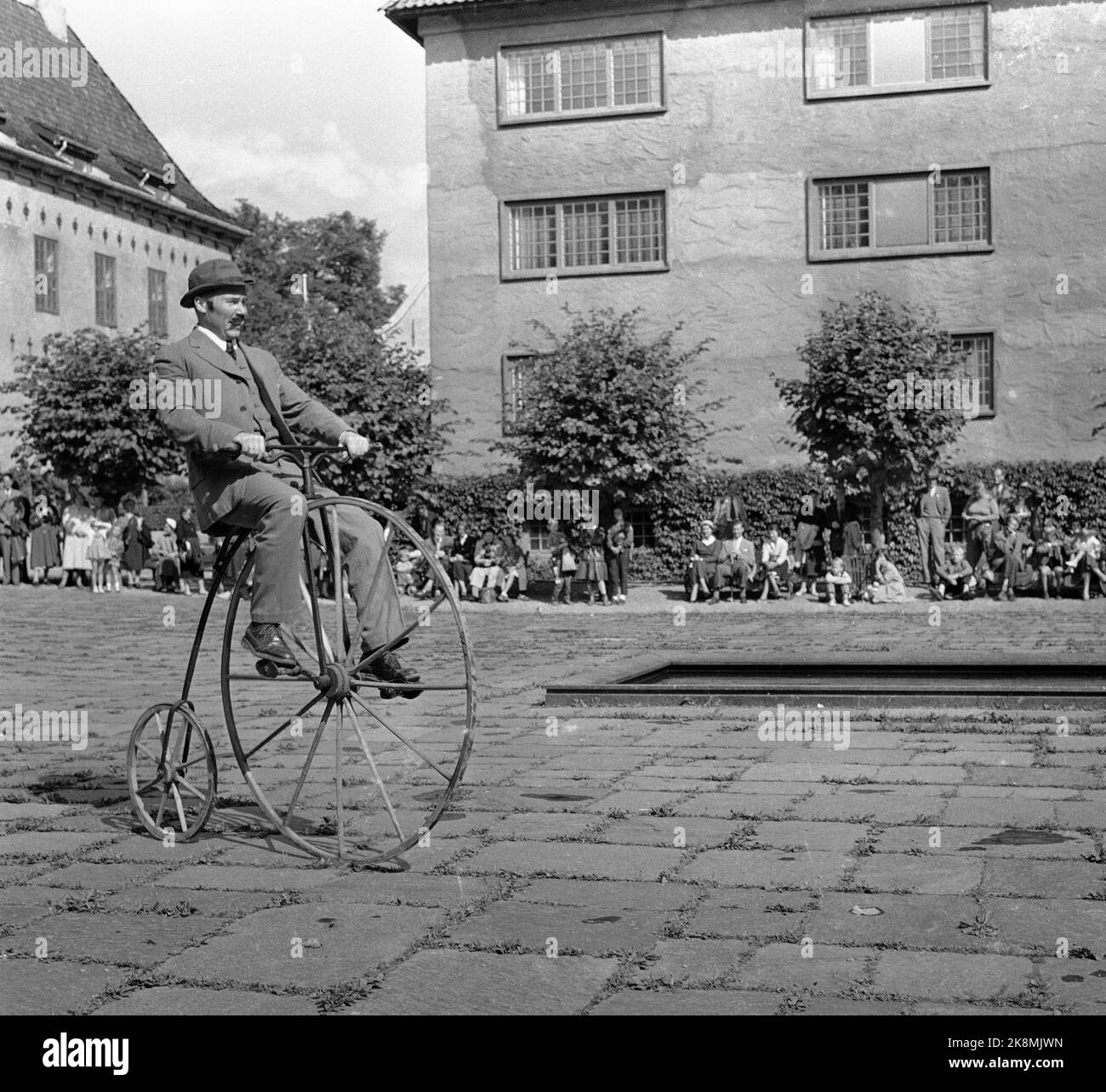 Bygdøy, Oslo 19570825 Parade of old bicycles at the Folk Museum. Man ...