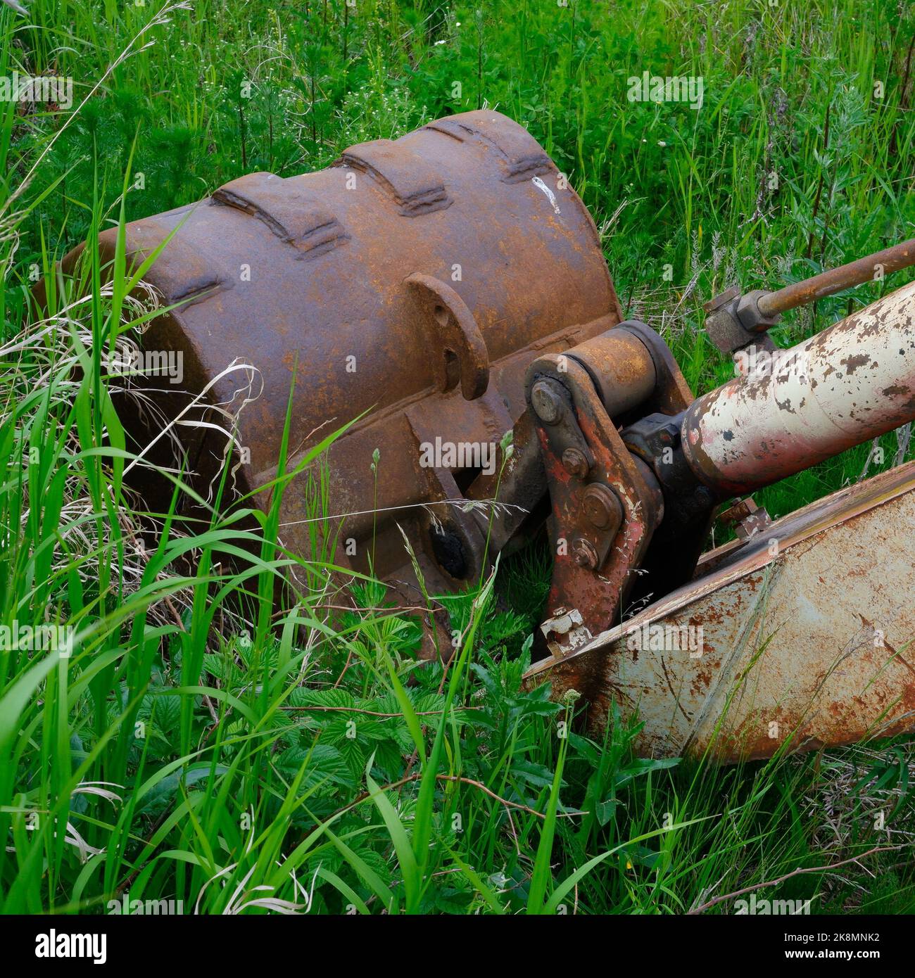 excavator bucket in the green grass Stock Photo - Alamy