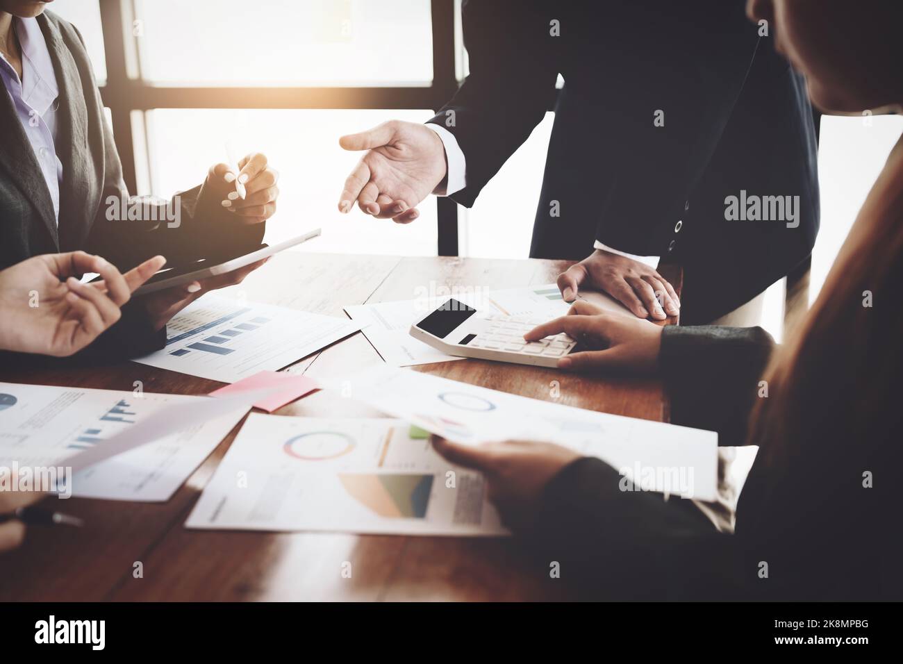 businesspeople working with partners is adjusting marketing strategies ...